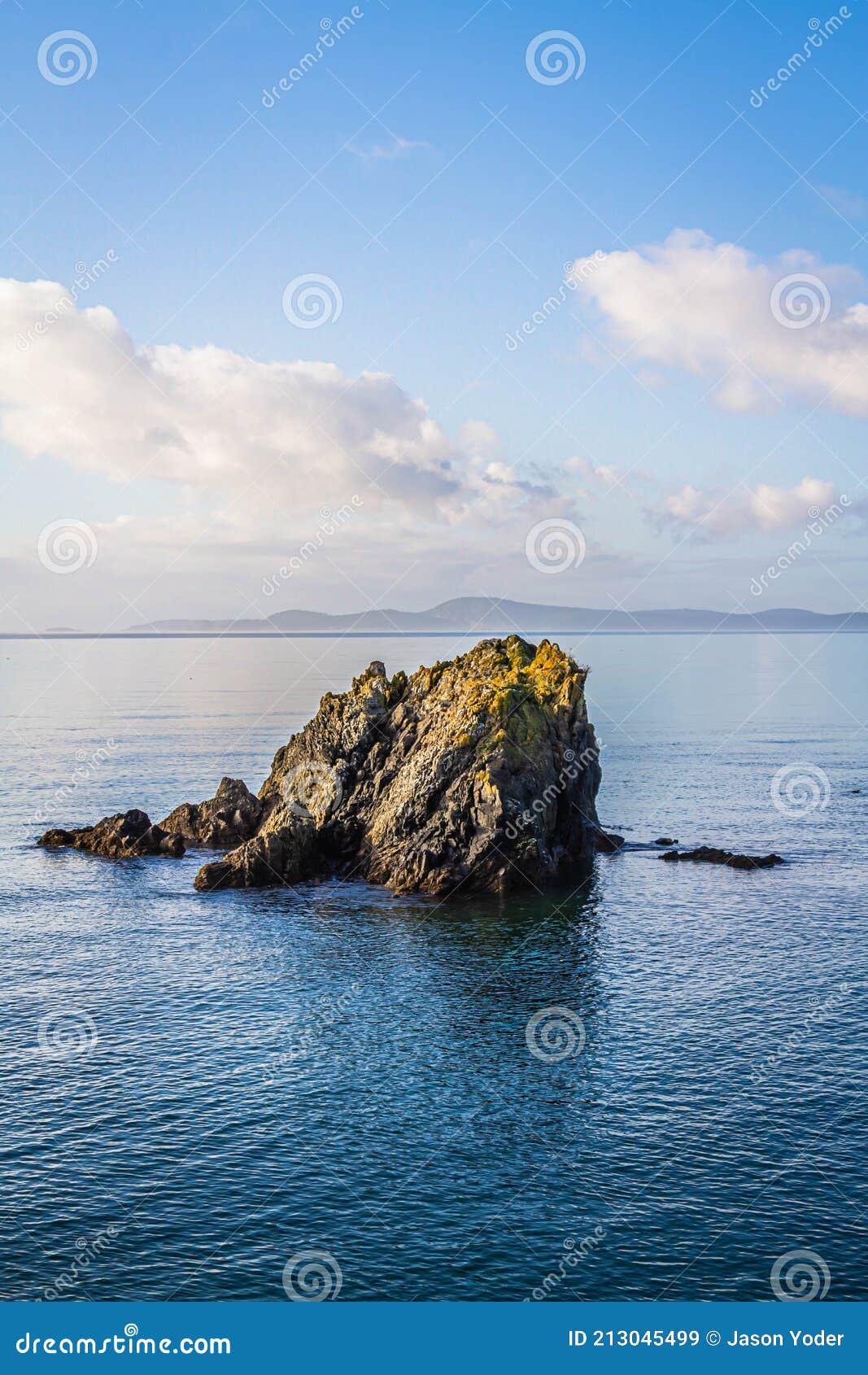 A Single Rock Protruding from the Surrounding Blue Ocean Stock Image ...