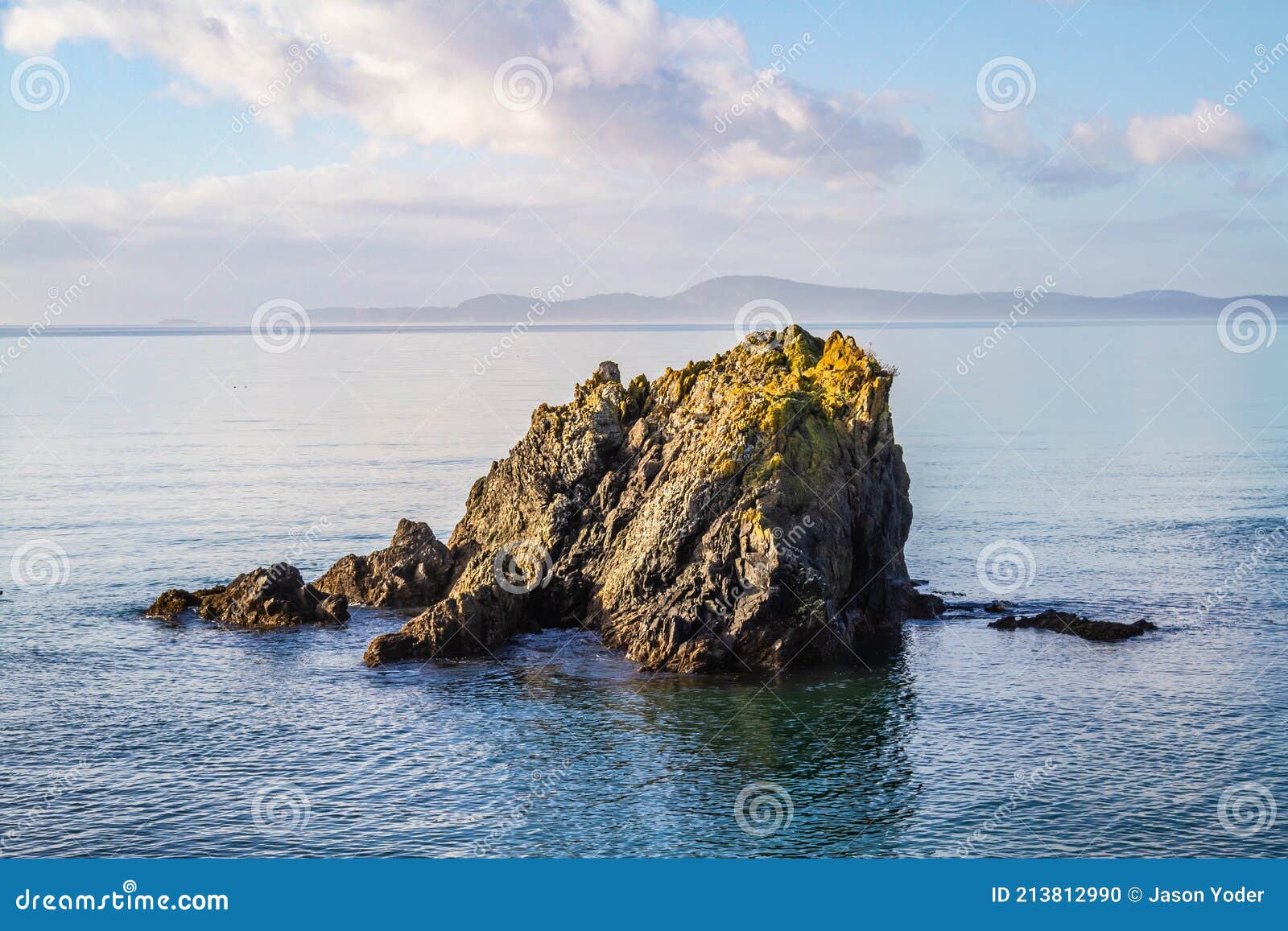 A Single Rock Protruding from the Surrounding Blue Ocean Stock Photo ...