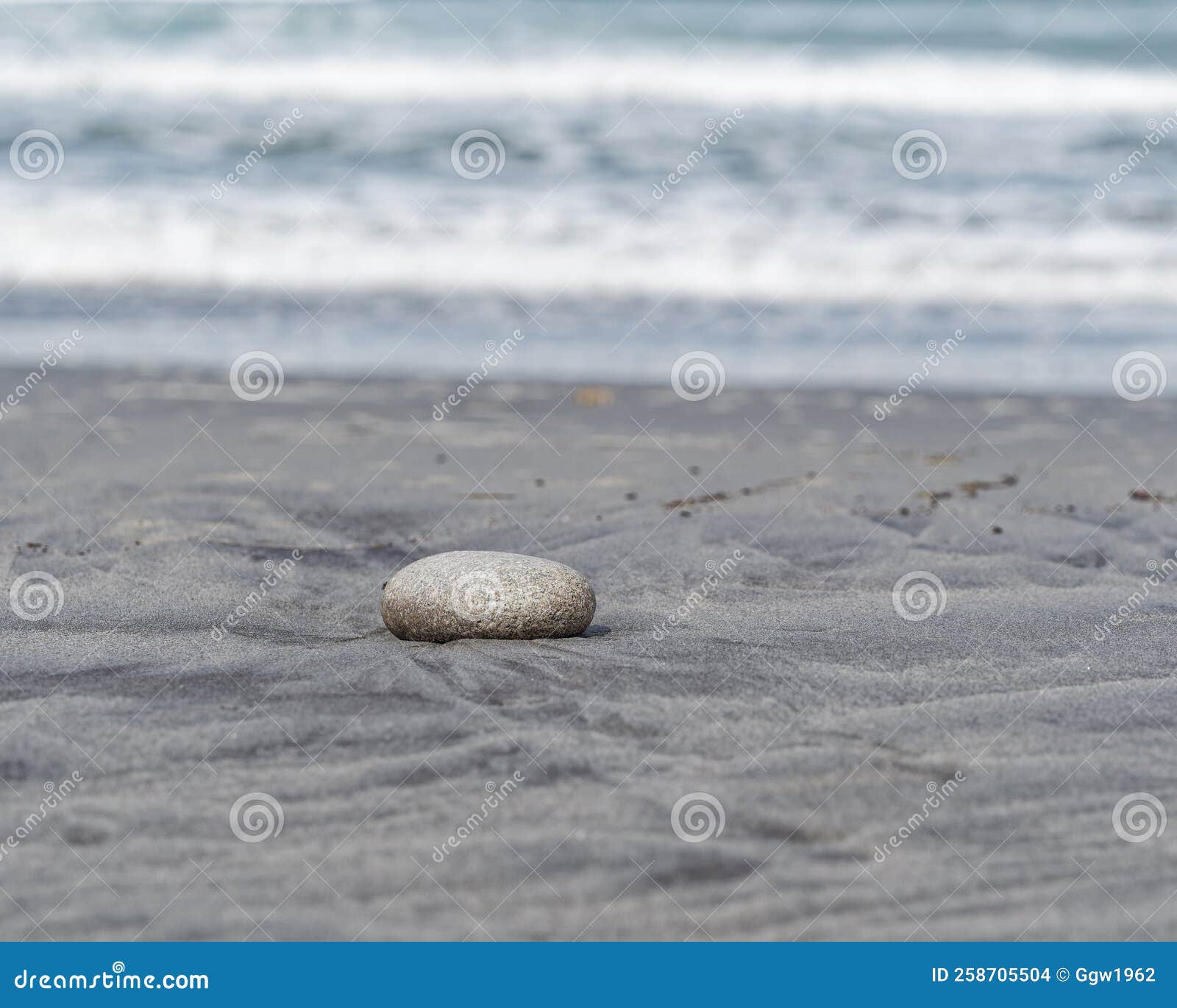 A Single Rock on a Snady Beach Stock Photo - Image of large, background ...