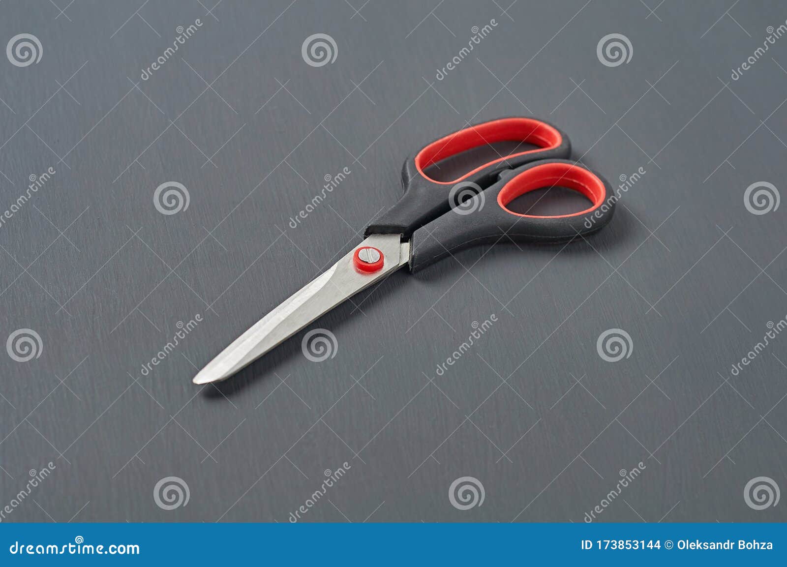 Single Sharp Scissors with Plastic Handle Black and Red Colors Lies on ...