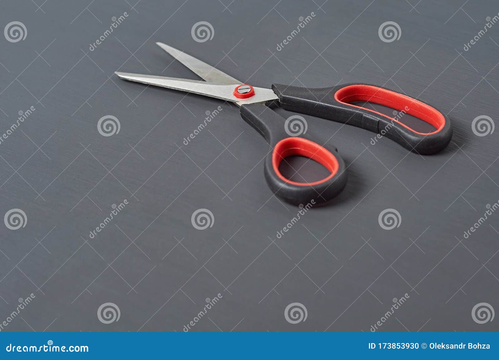 Single Sharp Scissors with Plastic Handle Black and Red Colors Lies on ...