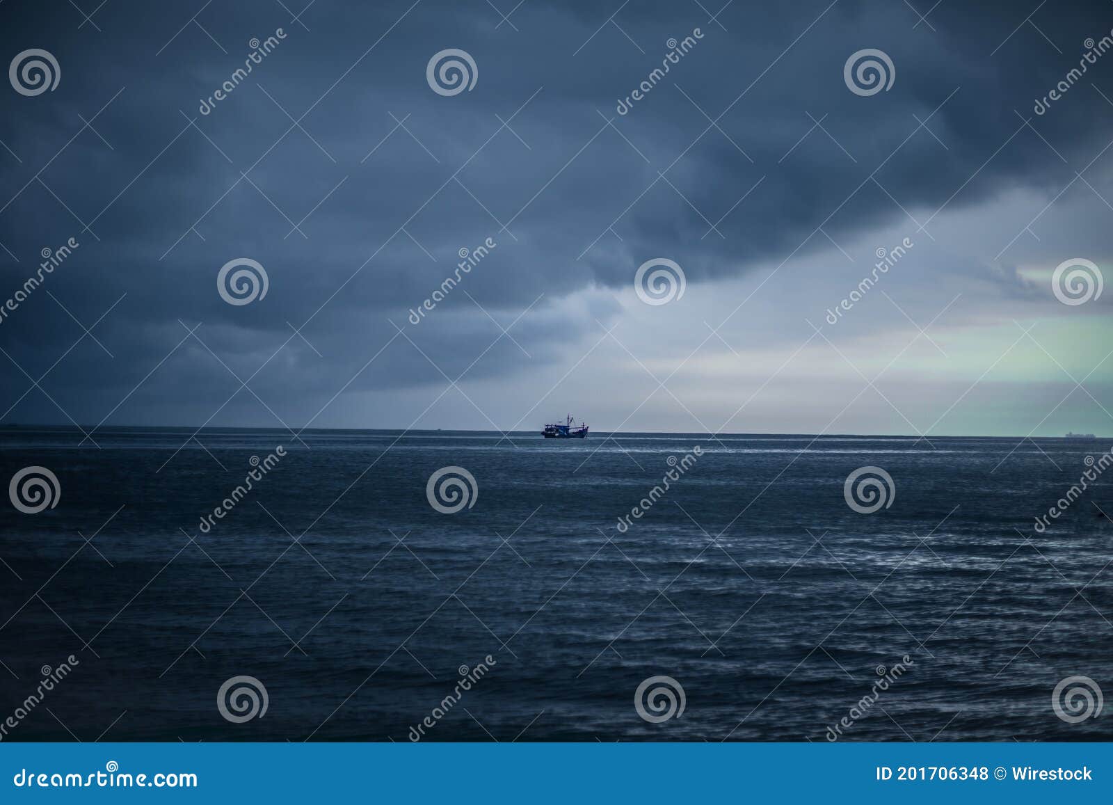Single Ship on the Calm Sea Under the Clouds in the Evening Stock Photo ...
