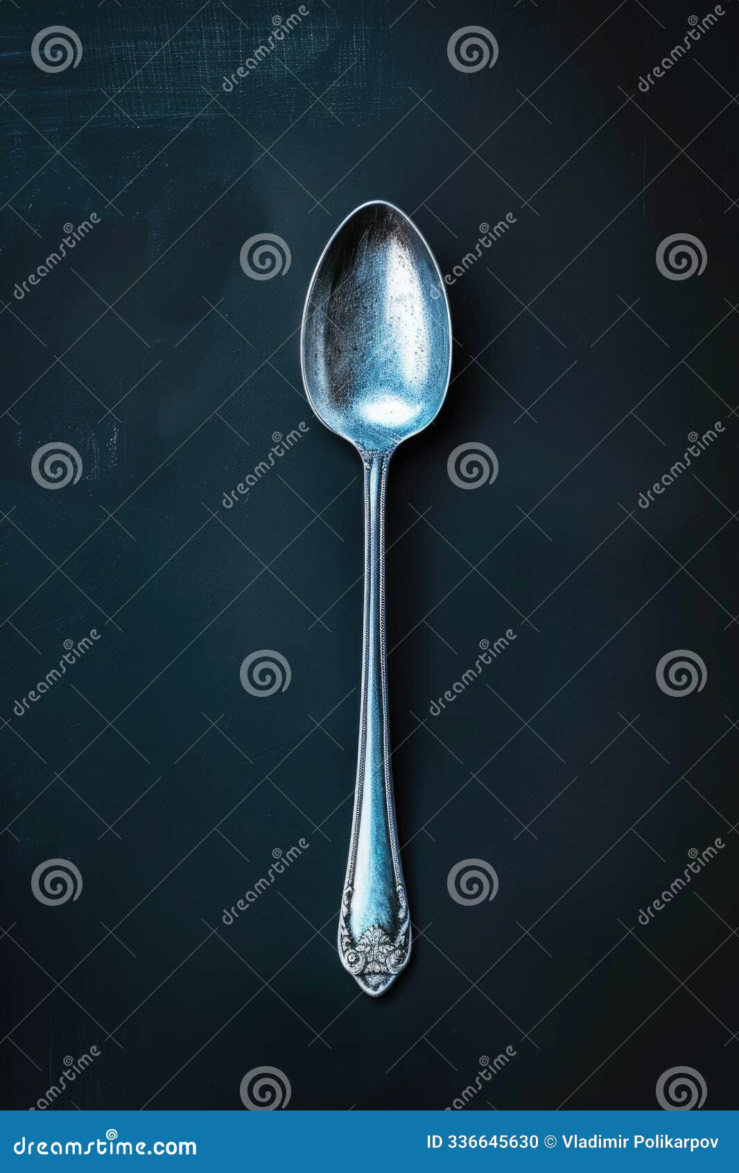 A Single Silver Spoon Lying on a Dark or Black Surface Stock Photo ...
