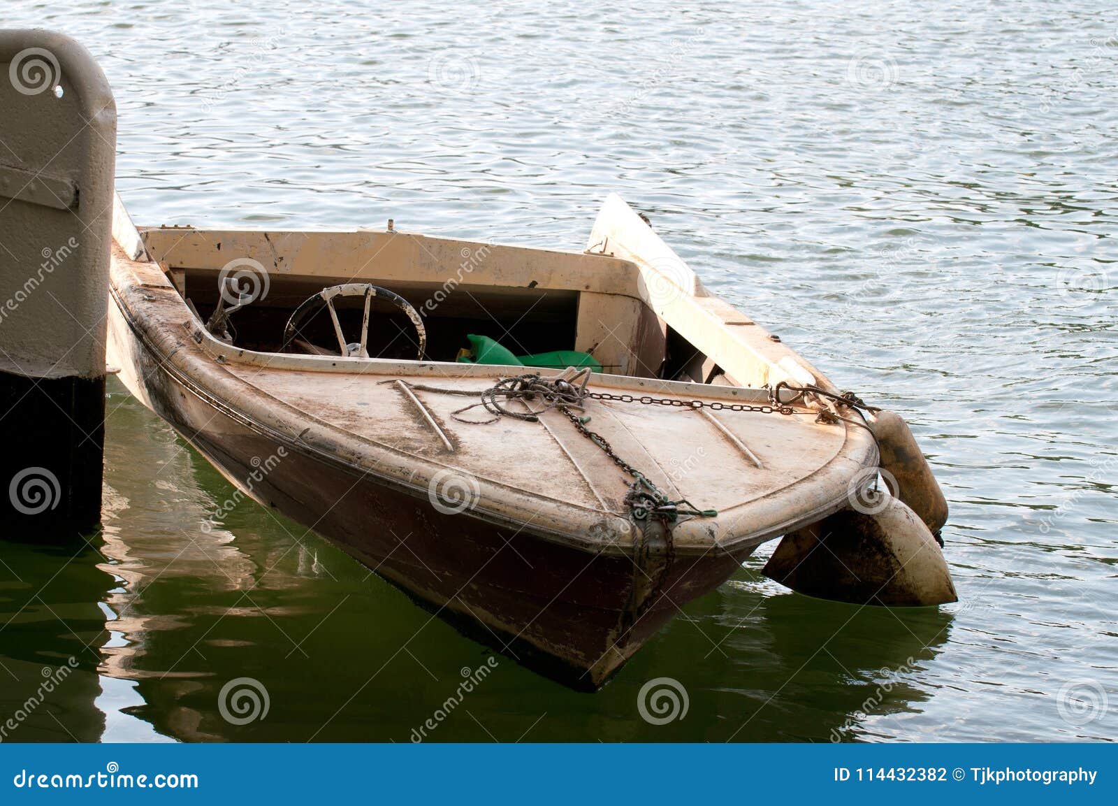 A Rusty Boat Sitting in the Water Stock Photo - Image of boat, lake ...