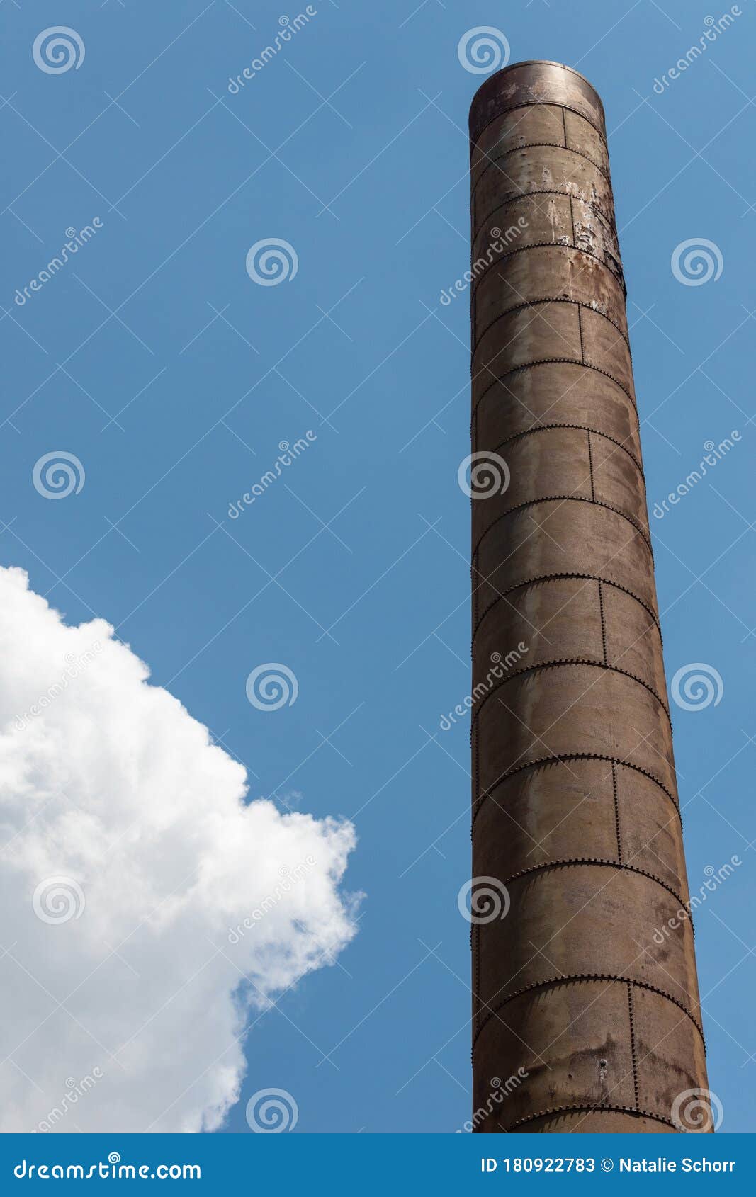 Single Smoke Stack Stretching High into Blue Sky with Cloud, Copy Space ...