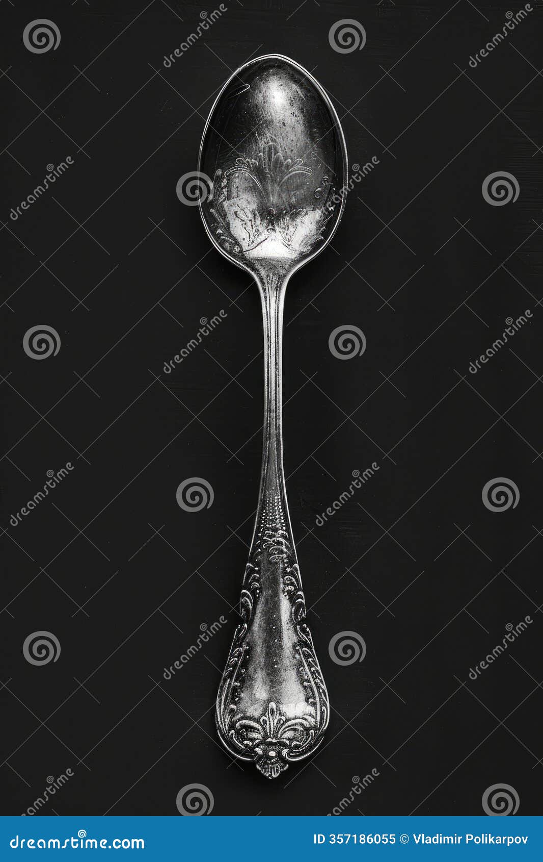 A Single Spoon on a Black Surface with a Black Background Stock Image ...