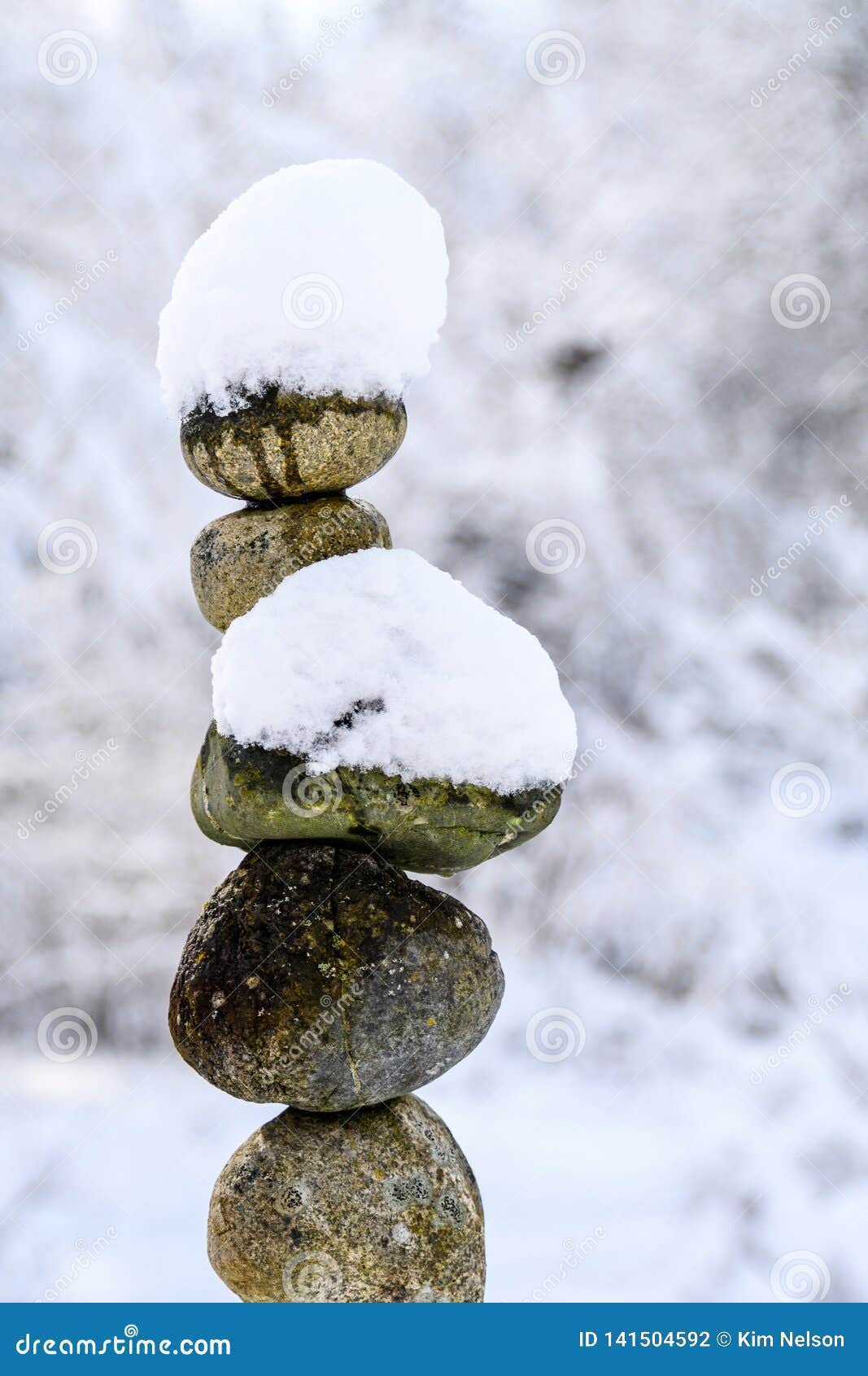 Single Stack of Snow Covered Round Rocks in a Peaceful Snowy Zen Garden ...
