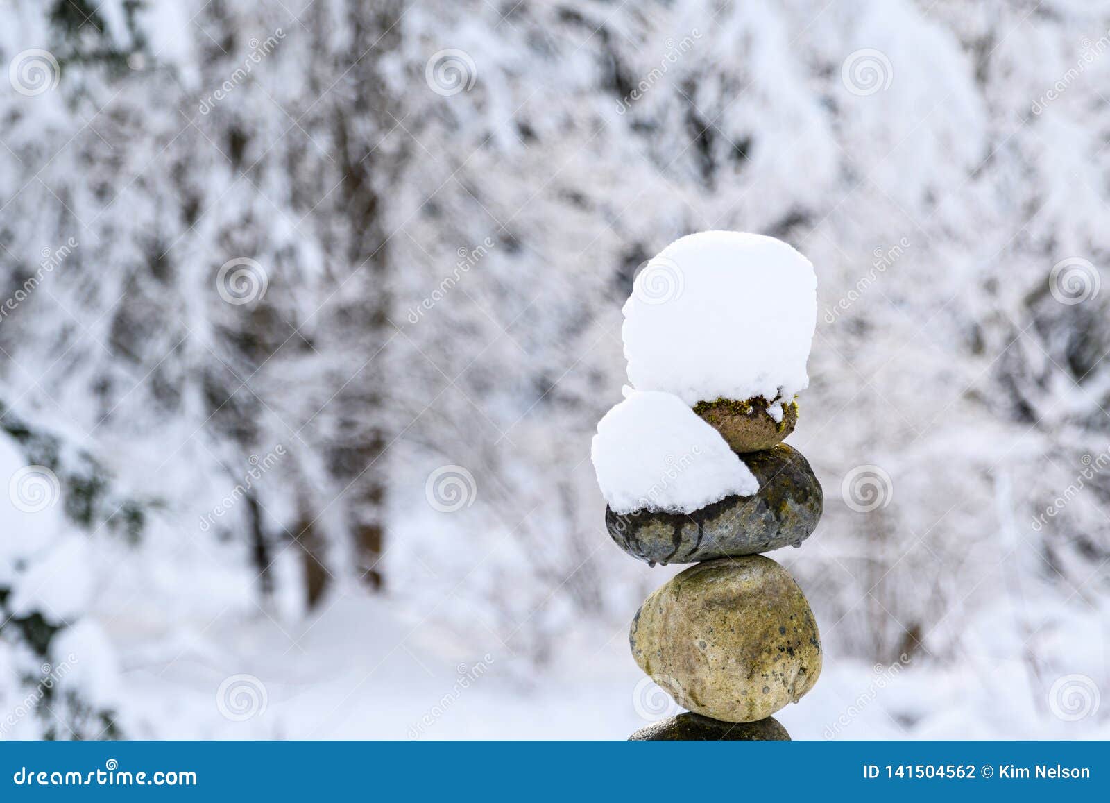 Single Stack of Snow Covered Round Rocks in a Peaceful Snowy Zen Garden ...