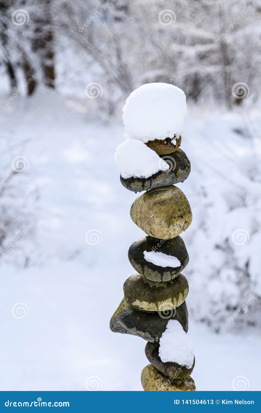Single Stack of Snow Covered Round Rocks in a Peaceful Snowy Zen Garden ...