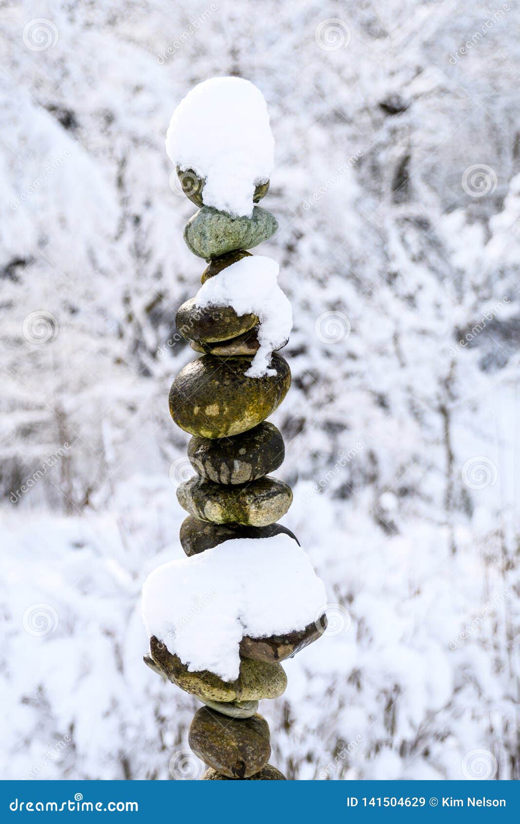 Single Stack of Snow Covered Round Rocks in a Peaceful Snowy Zen Garden ...