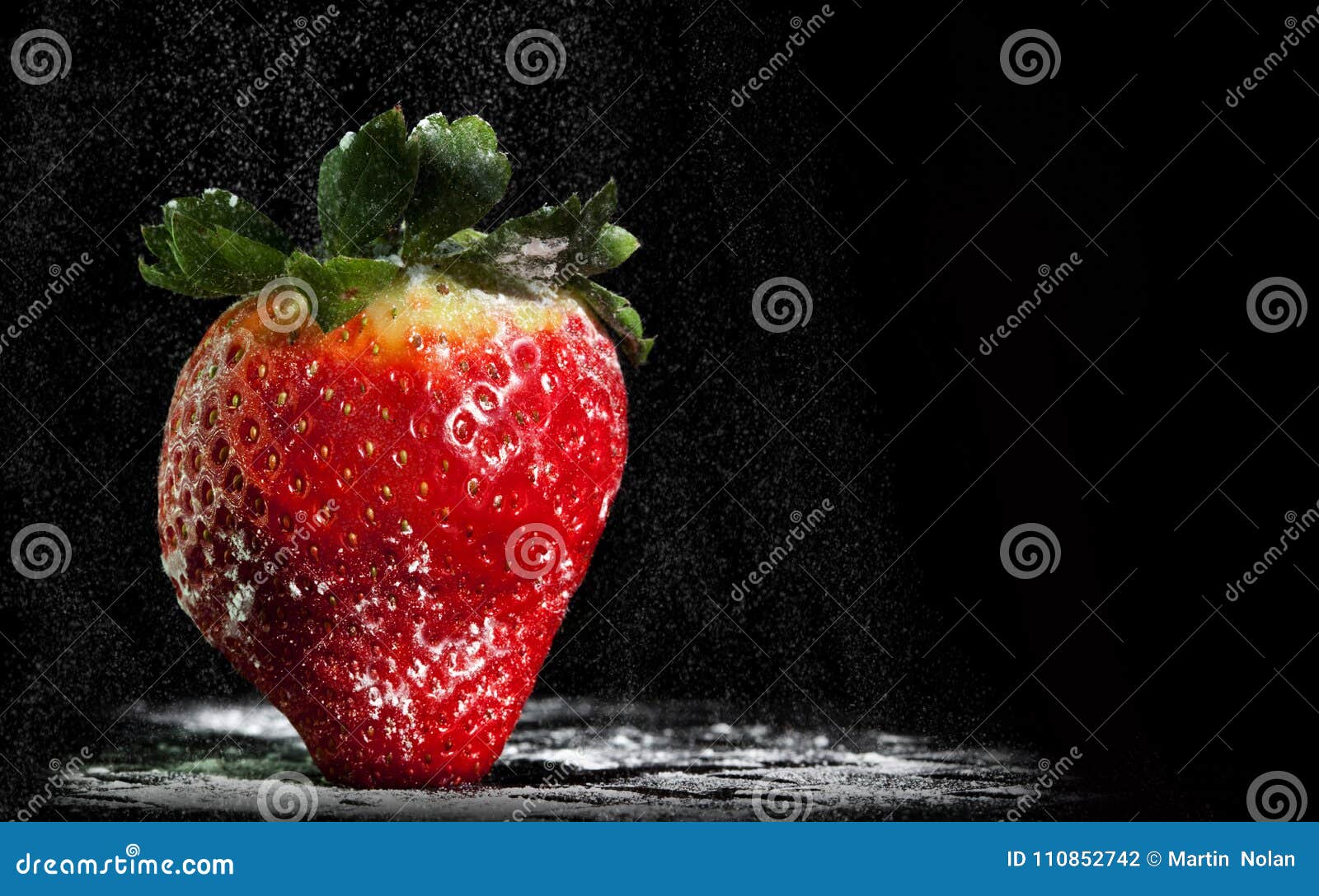 Single Strawberry with a Dusting of Icing Sugar Stock Photo - Image of ...