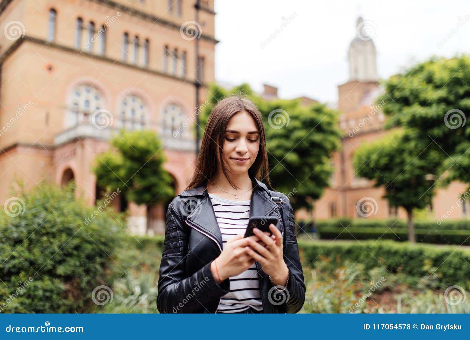 Single Student Walking and Reading Mobile Phone Messages with a ...