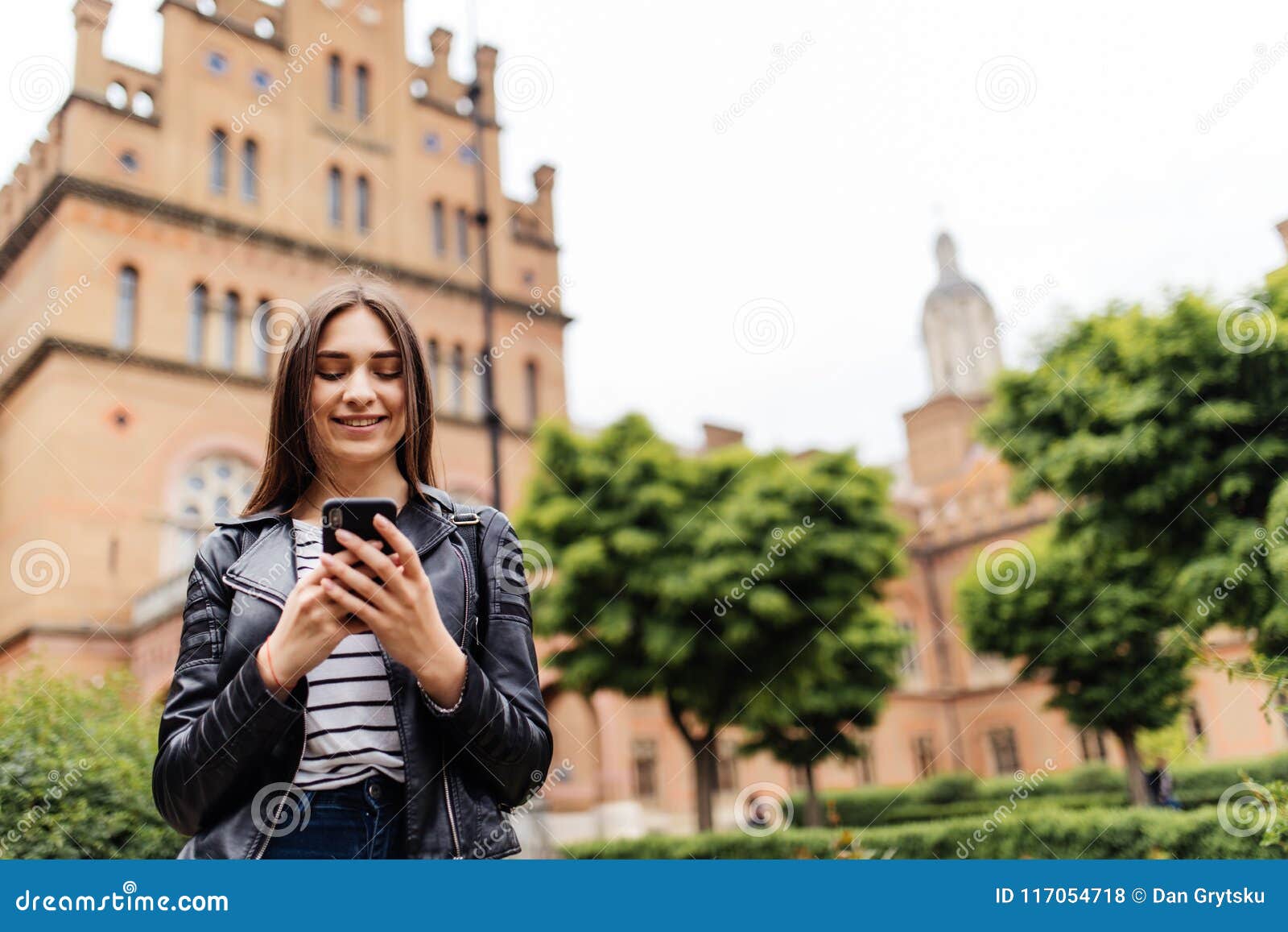Single Student Walking and Reading Mobile Phone Messages with a ...