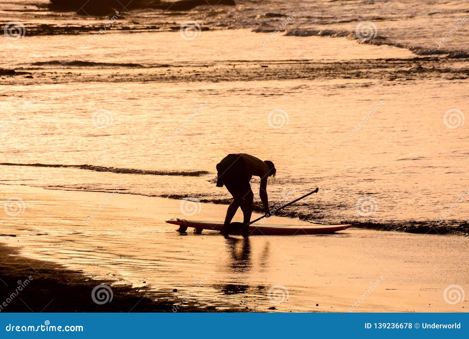 Surfer at Sunset on a Calm Ocean Stock Photo - Image of sunset, coast ...