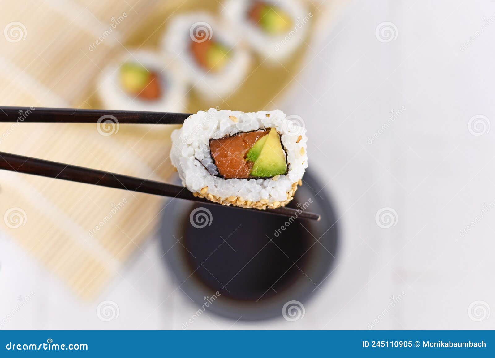 Single Sushi Inside Out Roll with Salmon, Avocado and Sesame Stock ...