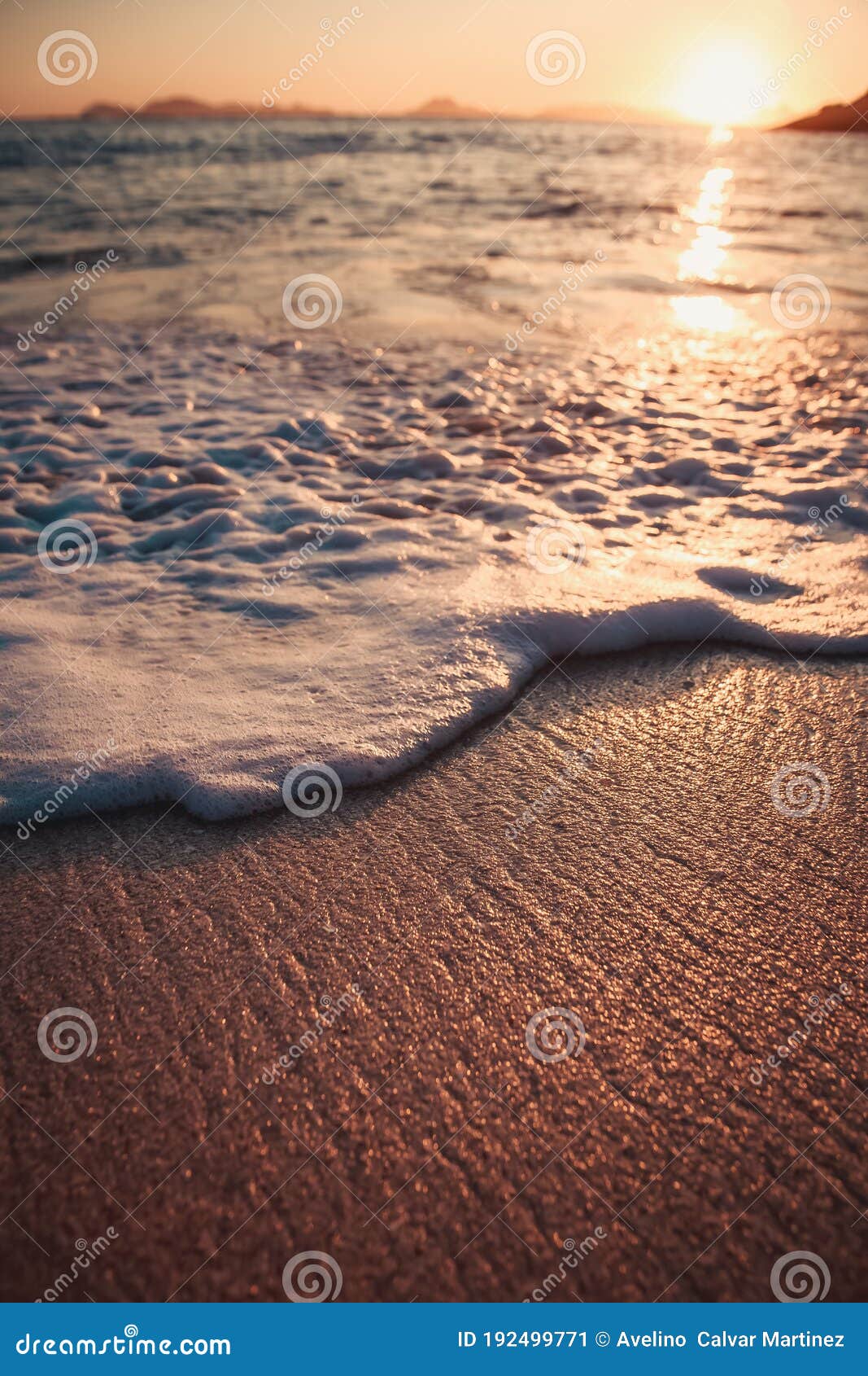 A Single Tide Going Over the Textured Sand of the Beach Stock Image ...