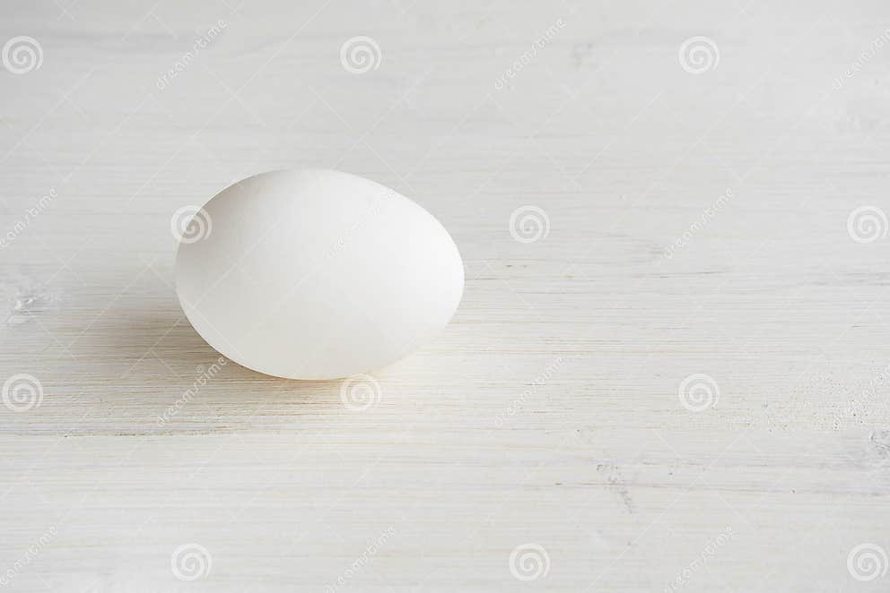 Single White Egg on a White Wooden Background Stock Image - Image of ...