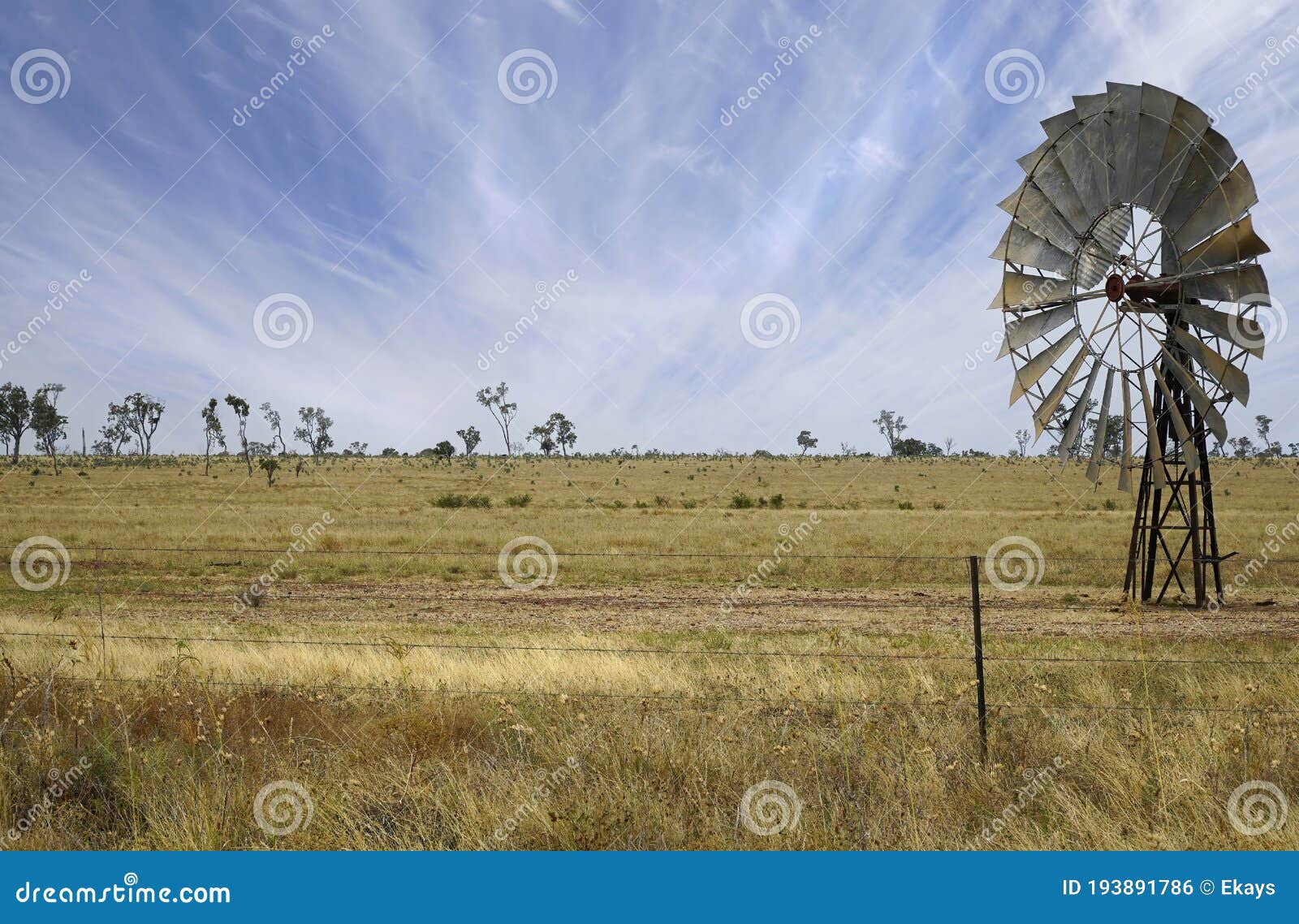 Single Windmill in Australia with Clouds Stock Photo - Image of ...