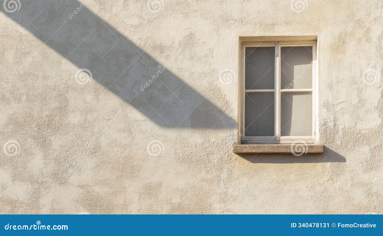 A Single Window on a Beige Wall with a Diagonal Shadow Stock ...