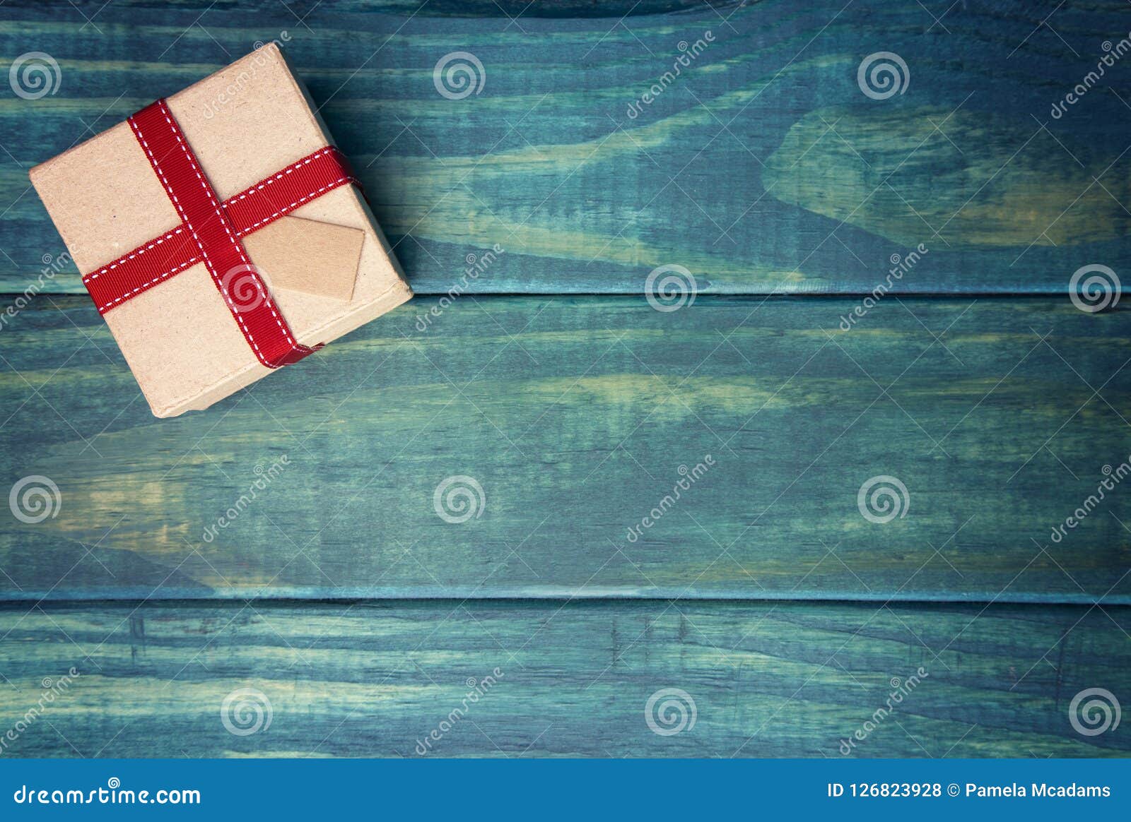 Single Small Gift Wrapped on a Blue Table Stock Photo - Image of area ...