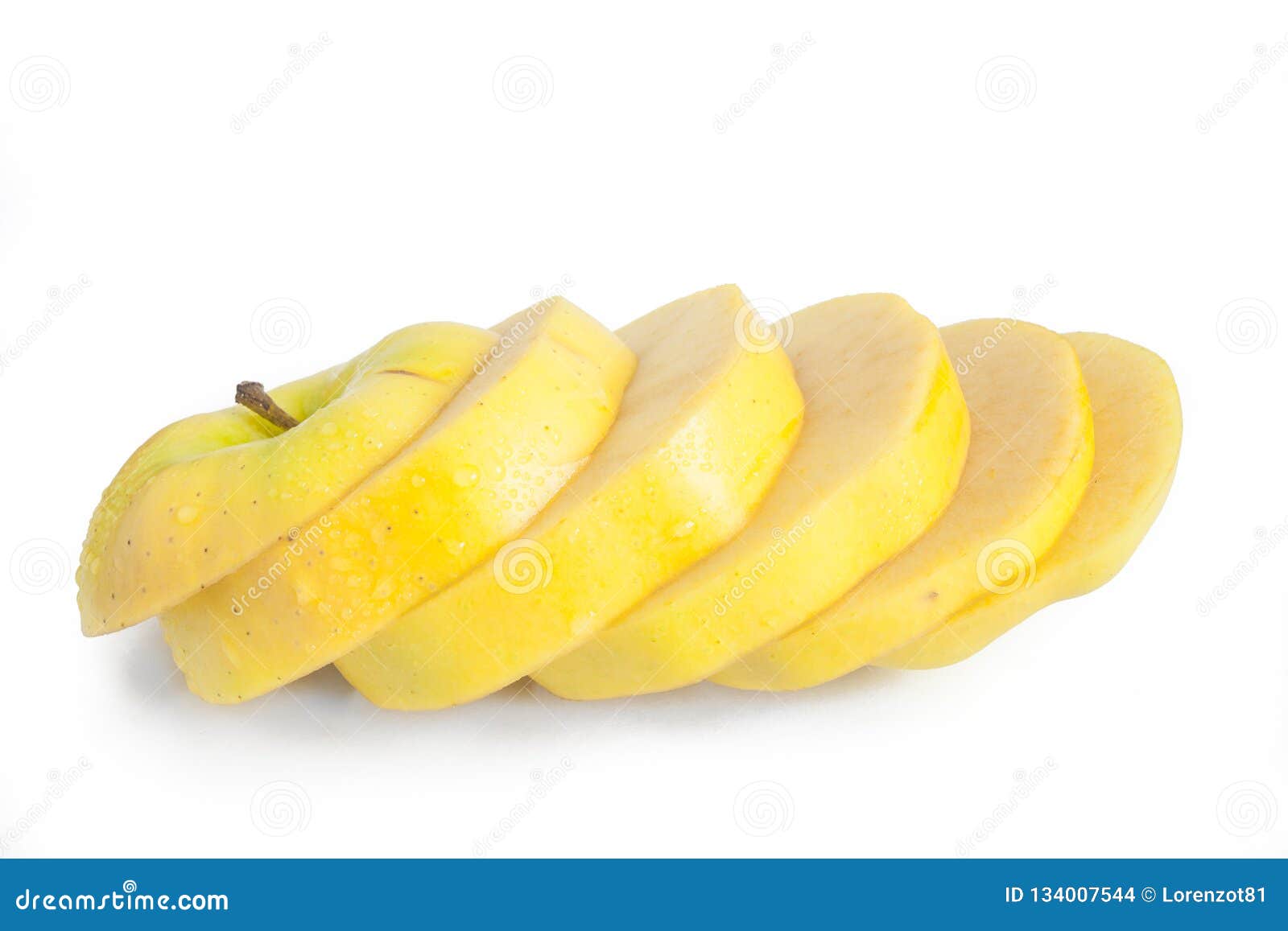 Single Yellow Apple Cut into Diagonal Slices Stock Photo - Image of ...
