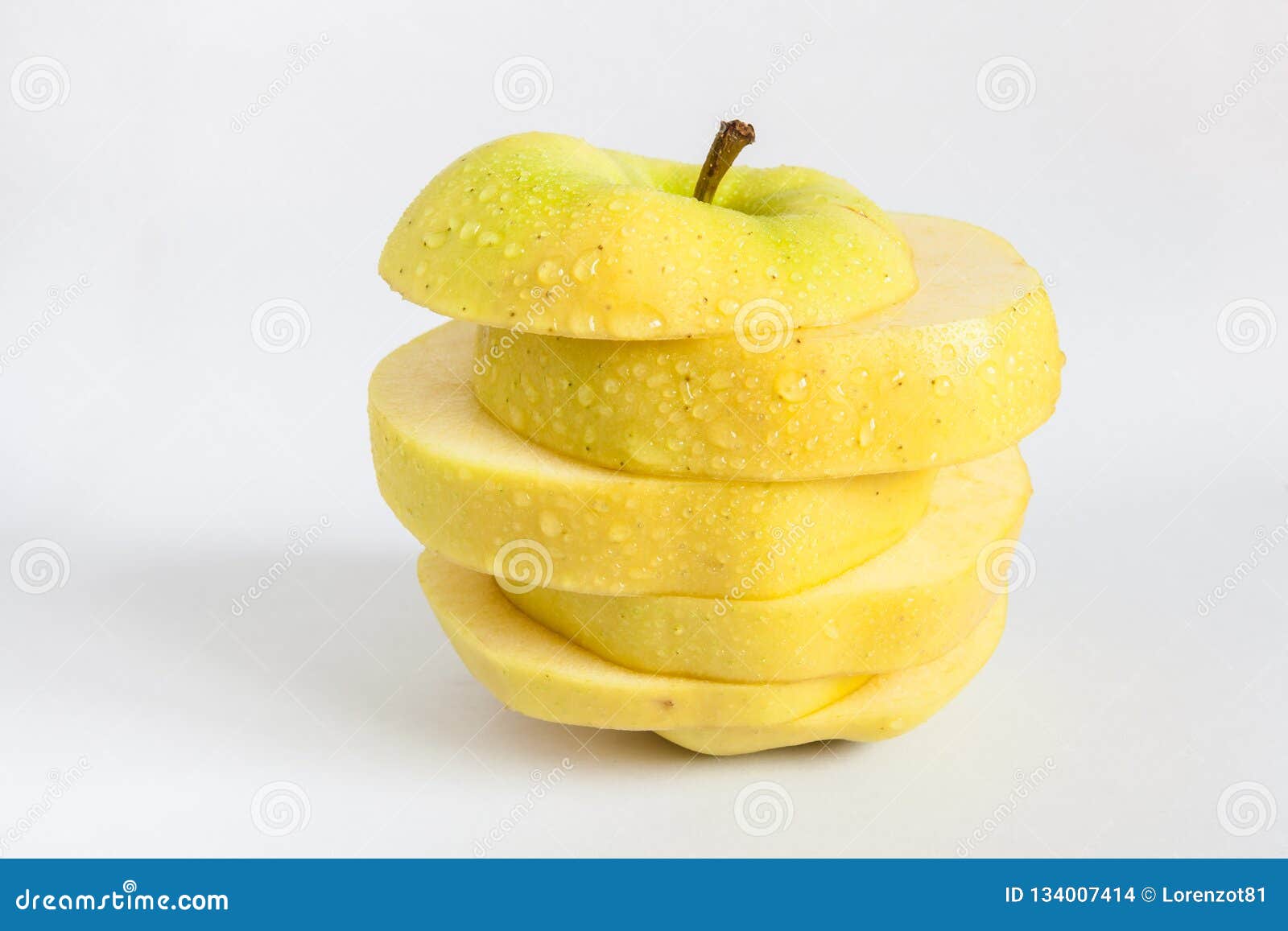Single Yellow Apple Cut into Horizontal Slices Stock Photo - Image of ...