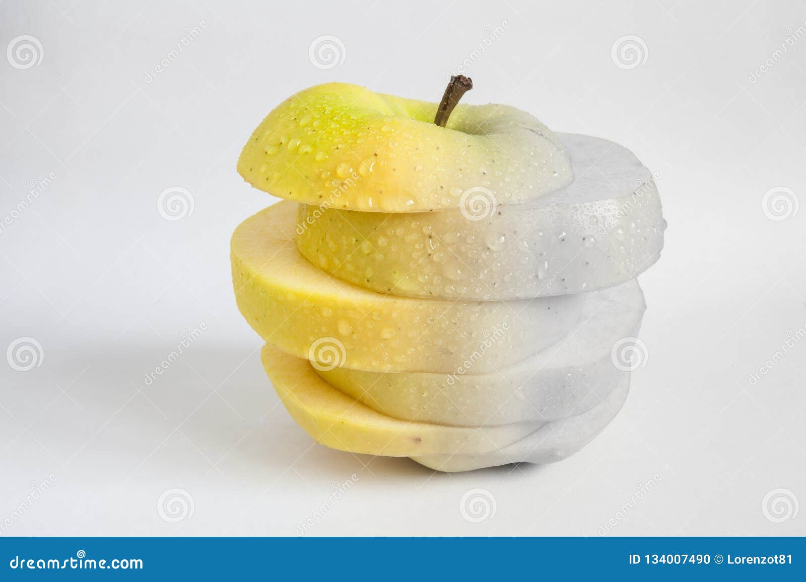 Single Yellow Apple Cut into Horizontal Slices Stock Photo - Image of ...