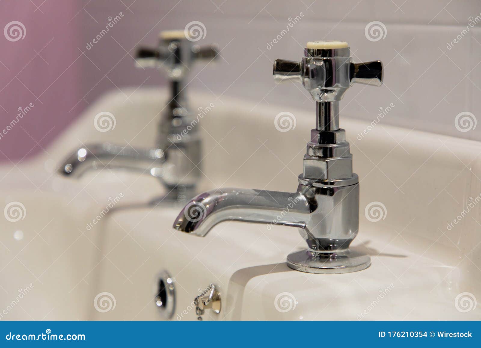 Sink with Metal Water Taps Inside a Bathroom Stock Photo - Image of ...
