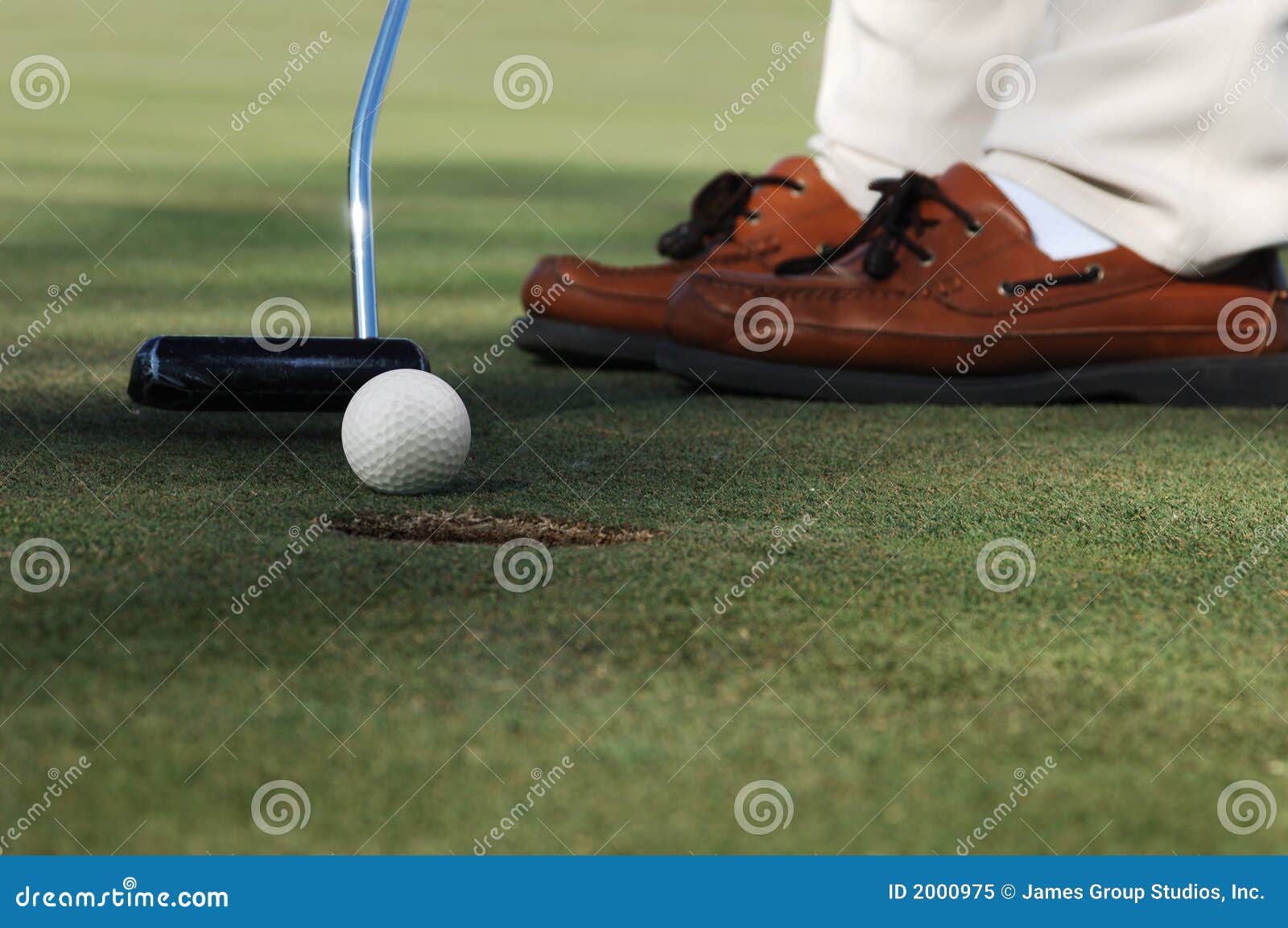 Sinking the putt stock image. Image of hole, golf, legs - 2000975