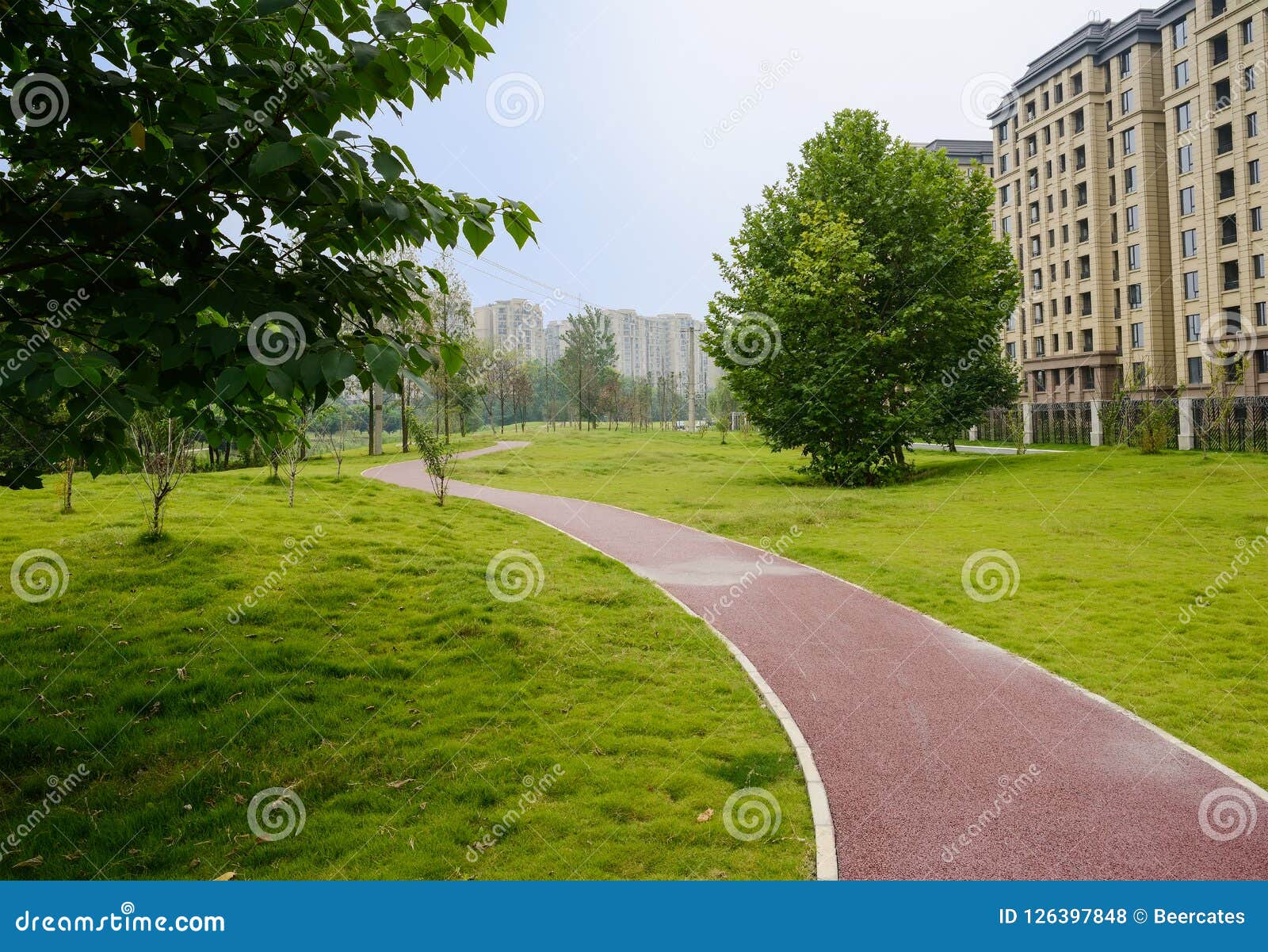 Sinuous Red Path before Storied Apartments Stock Photo - Image of ...