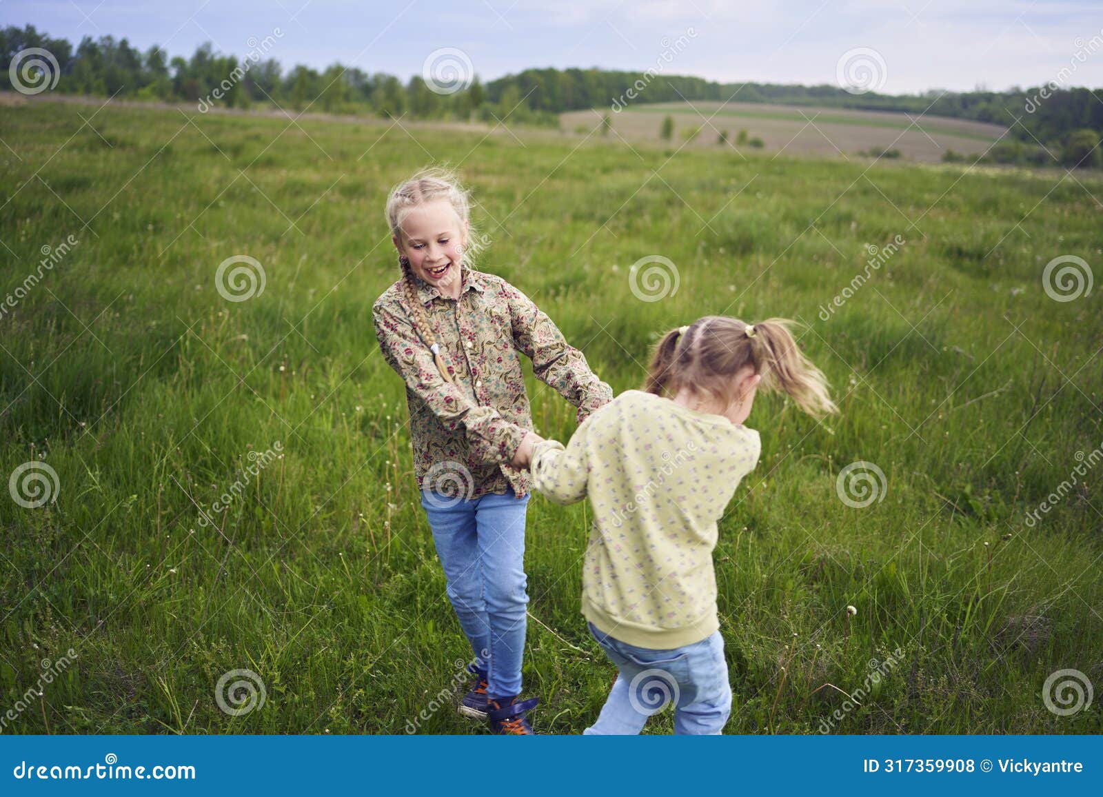 Sisters Hug and Protect Each Other from the Wind in the Field Stock ...