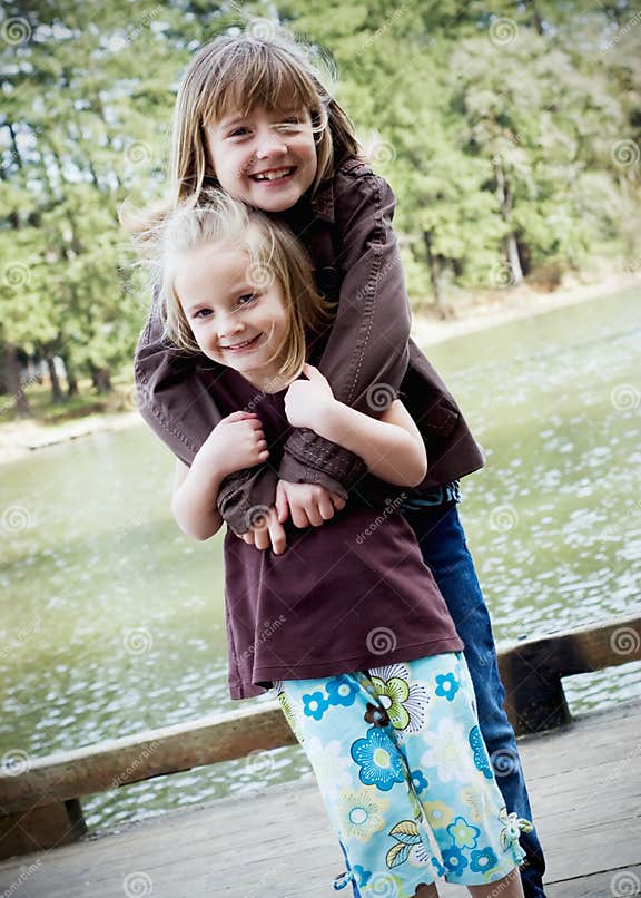 Sisters Hugging stock photo. Image of precocious, hair - 5235384