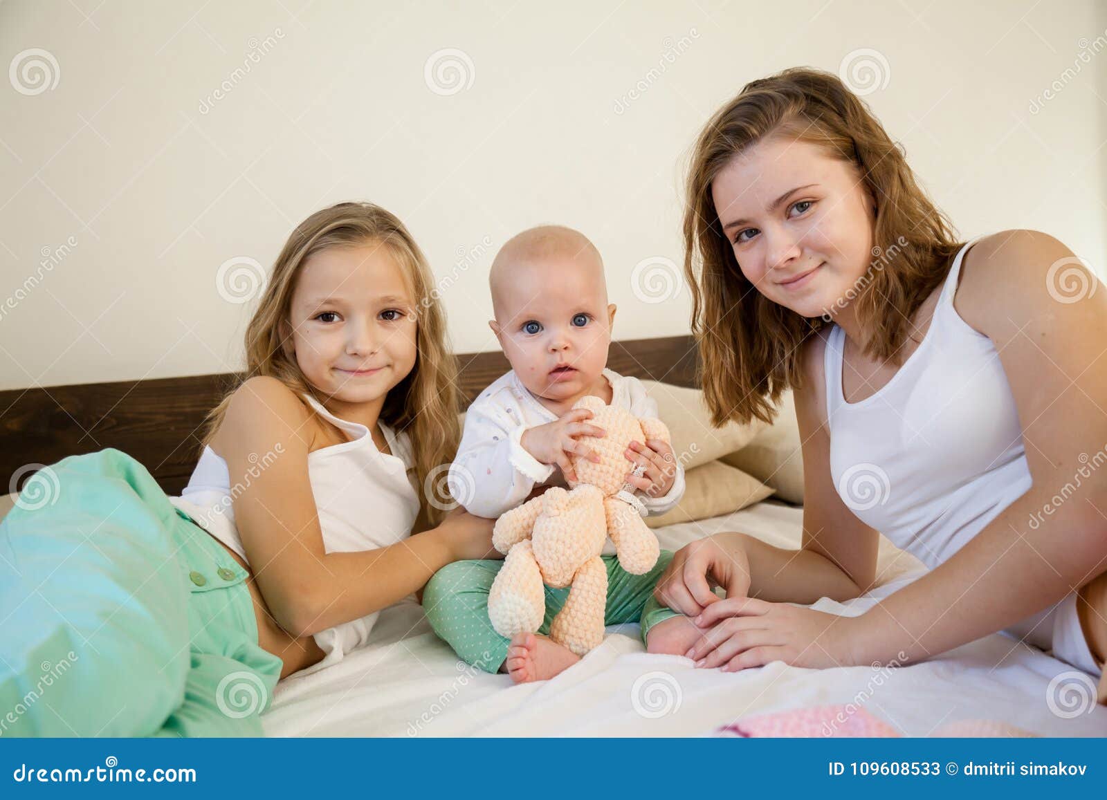 Sisters Play with the Baby on the Bed in the Bedroom Stock Image ...