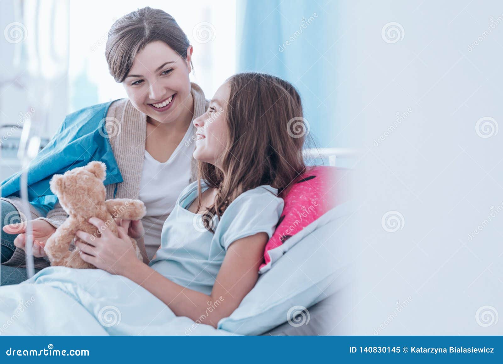 Sisters Smiling and Sitting Together in Bed in the Hospital Stock Image ...