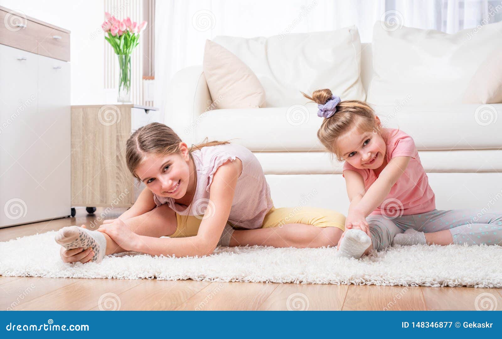 SIsters Stretching on the Floor Stock Image - Image of body, girl ...