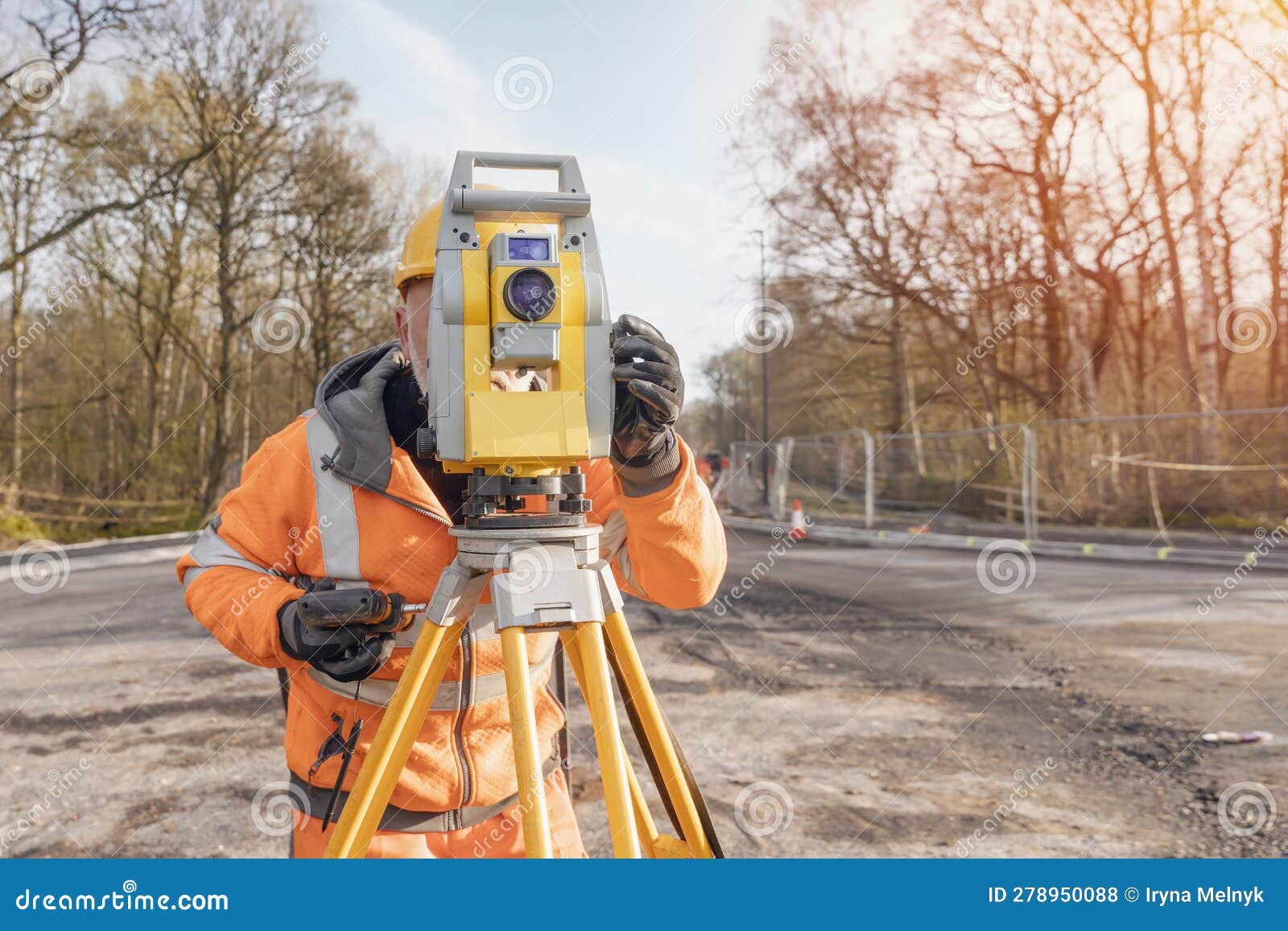 Site Engineer Operating His Instrument during Roadworks. Builder Using ...