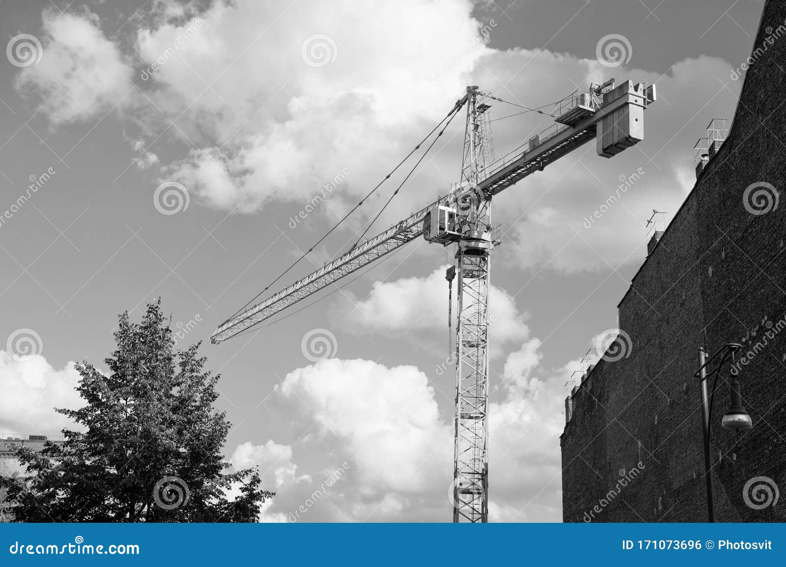 Site Under Construction. Construction Crane on Cloudy Sky. Crane for ...