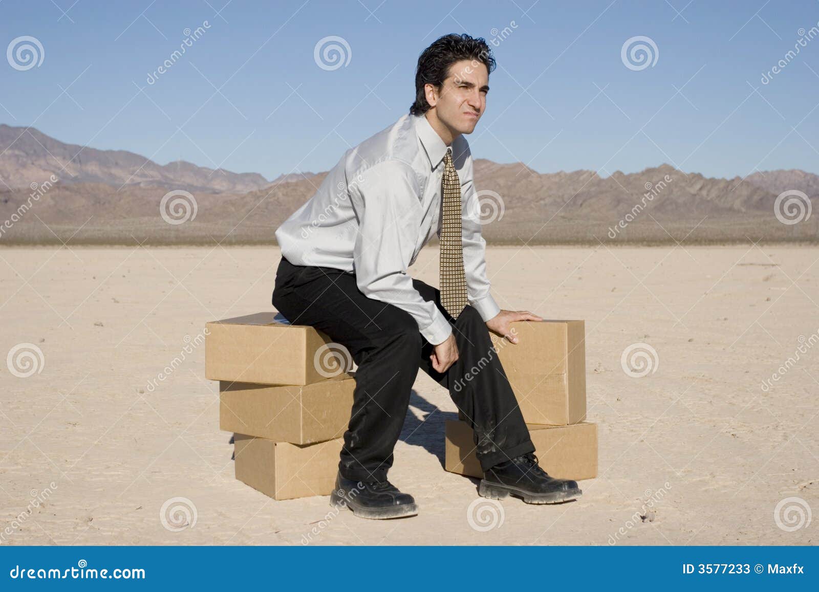 Sitting on boxes stock image. Image of businessman, desert - 3577233