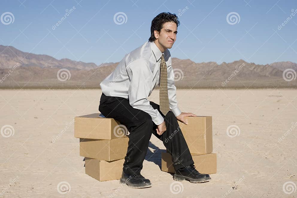 Sitting on boxes stock image. Image of businessman, desert - 3577233