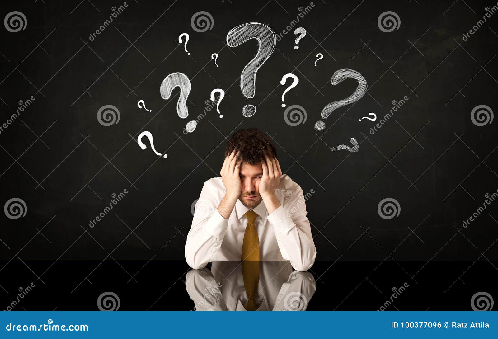 Sitting Businessman Under Question Marks Stock Photo - Image of ...