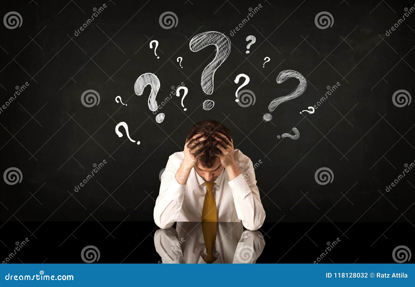 Sitting Businessman Under Question Marks Stock Photo - Image of ...