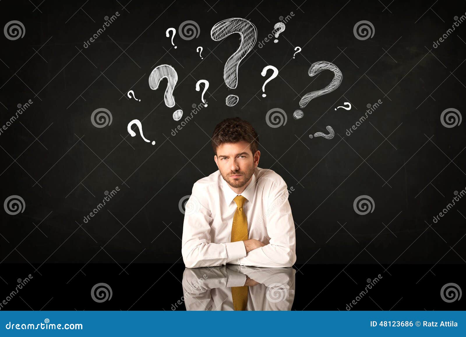 Sitting Businessman Under Question Marks Stock Photo - Image of ...