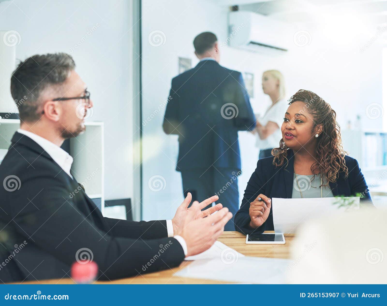 Sitting Down at the Idea Table. a Group of Corporate Colleagues Sitting ...