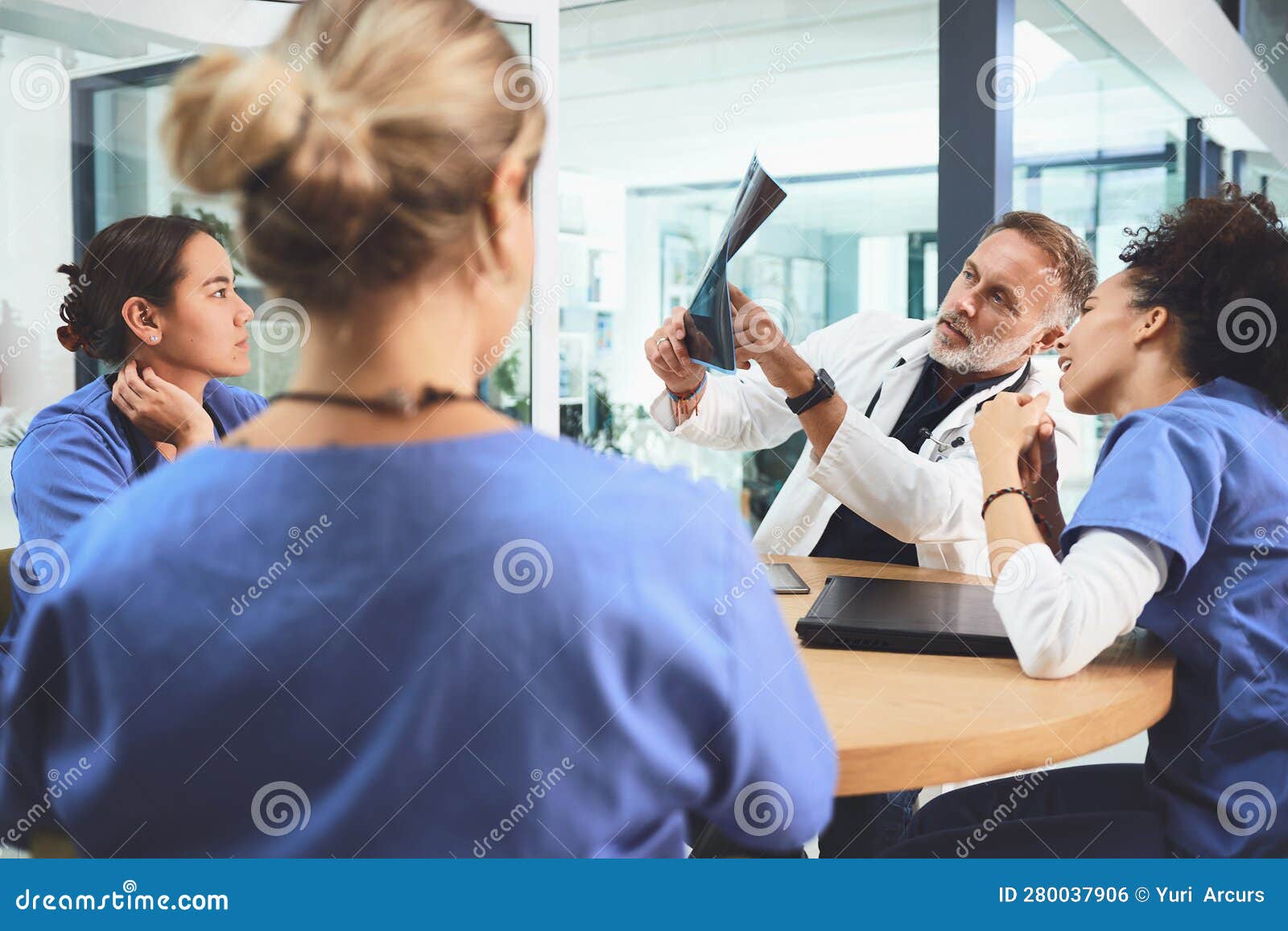 Sitting Down for Some Medical Problem Solving. a Team of Doctors ...