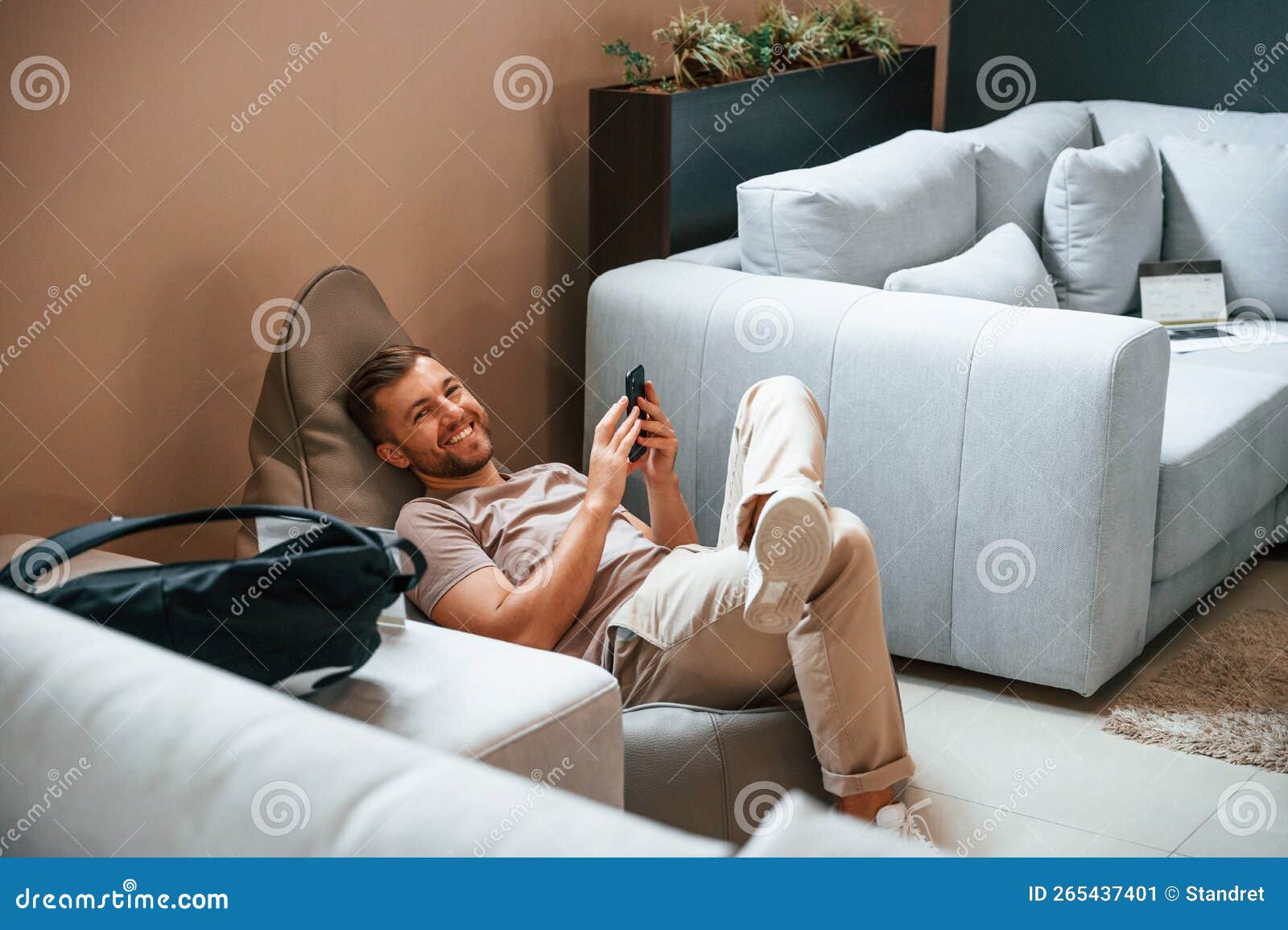 Sitting and Enjoying. Customer Visiting the Sofa and Bed Store Stock ...