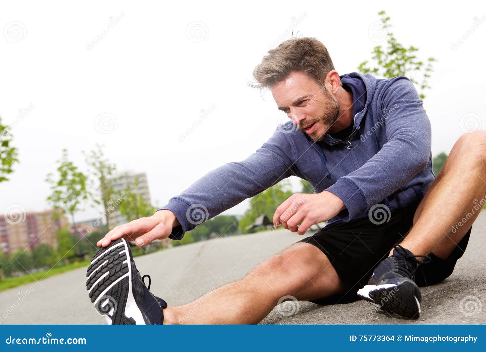 Sitting Male Runner Doing Stretch Stock Photo - Image of athletic ...