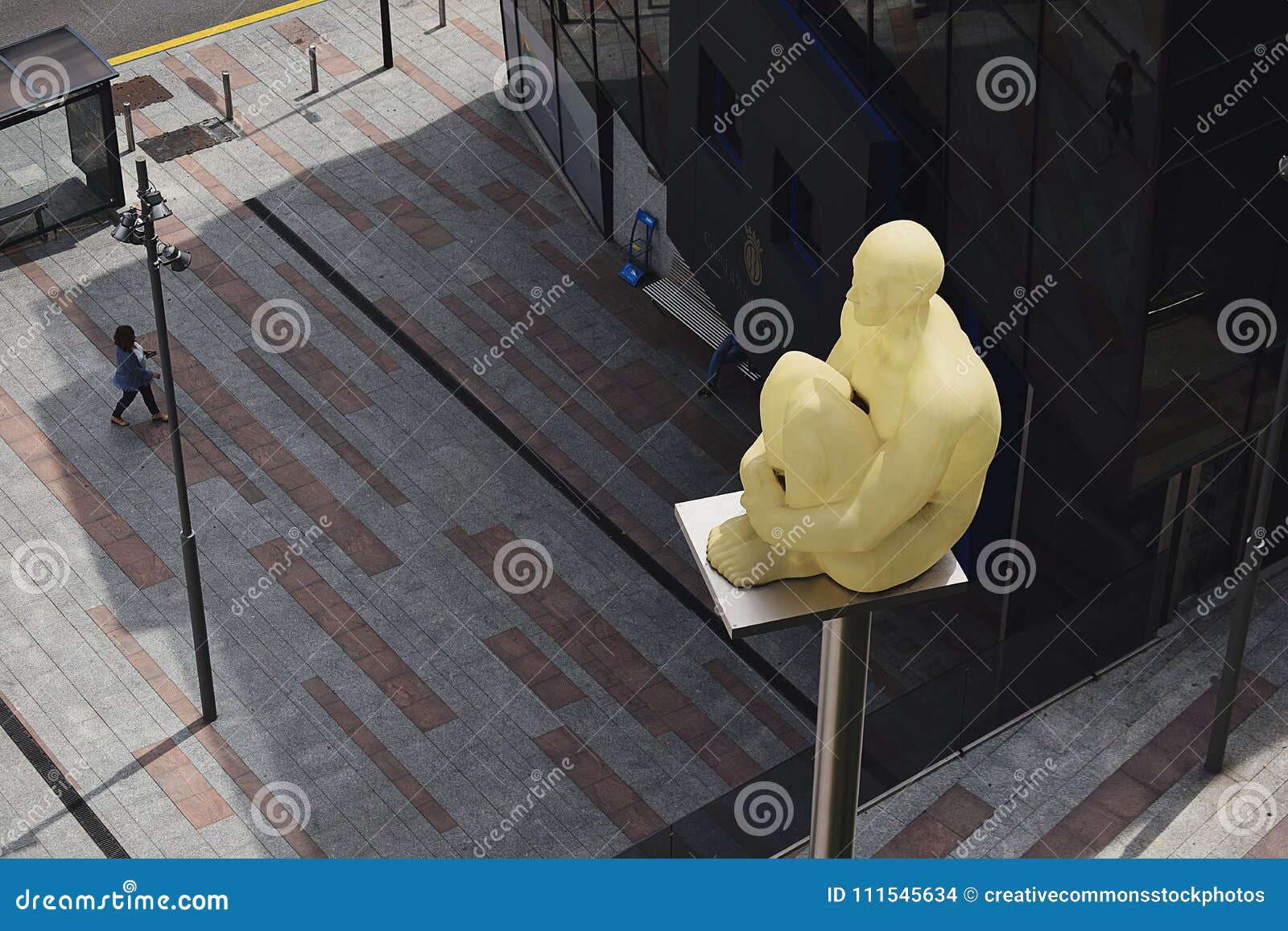 Sitting Man Statue Placed On Gray Metal Post Picture. Image: 111545634