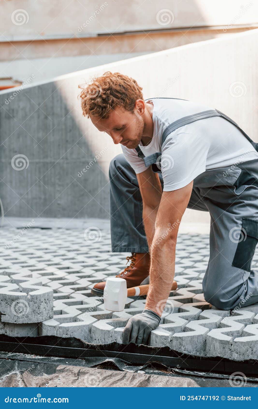 Sitting Outdoors. Young Man Working in Uniform at Construction at ...