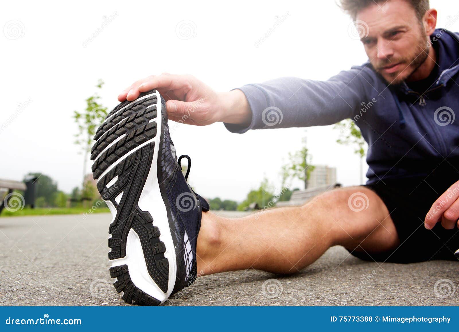 Sitting Runner Outside Doing Stretch in Street Stock Photo - Image of ...