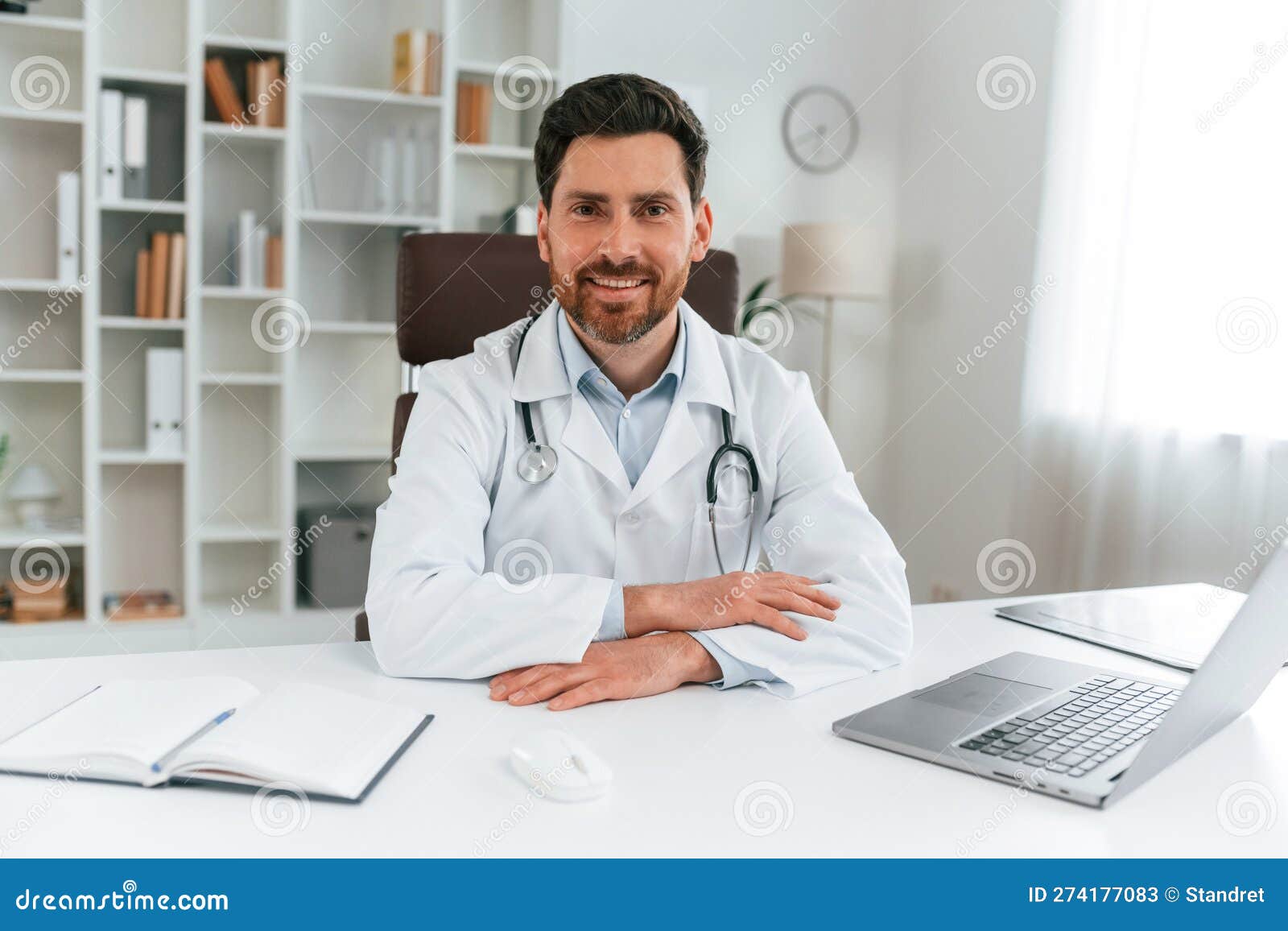 Sitting by a Table. Doctor in Formal Clothes is Working in the Cabinet ...